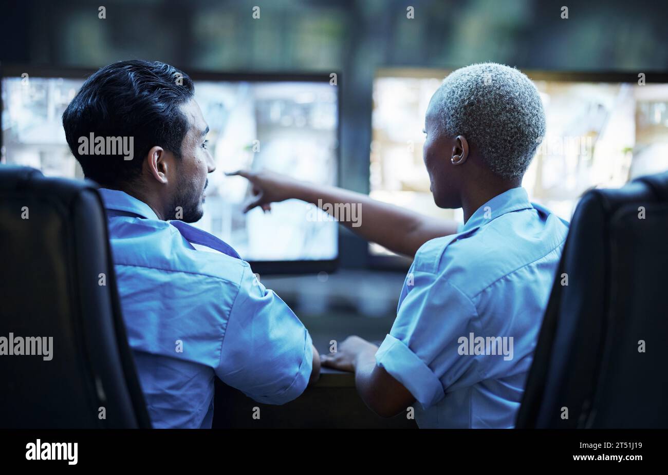 Security guard in control room, man and woman with screen to check cctv ...