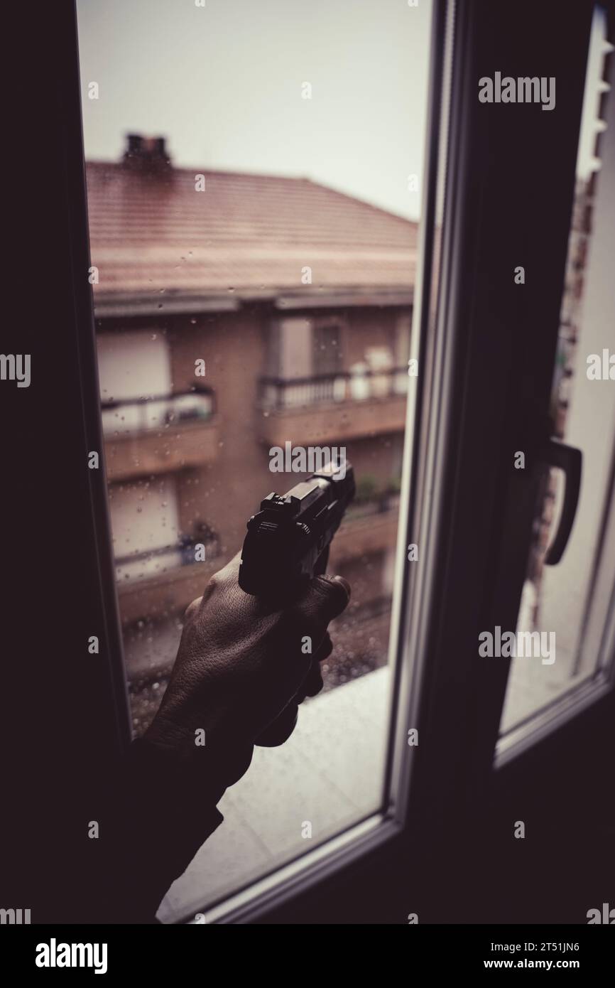 Gunman holding pistole in window dramatic photo book cover design Stock ...