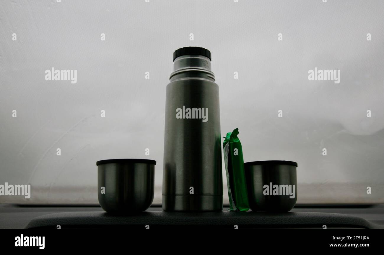 Sitting in the motor car on a wet and windy day, with a steel thermos ...