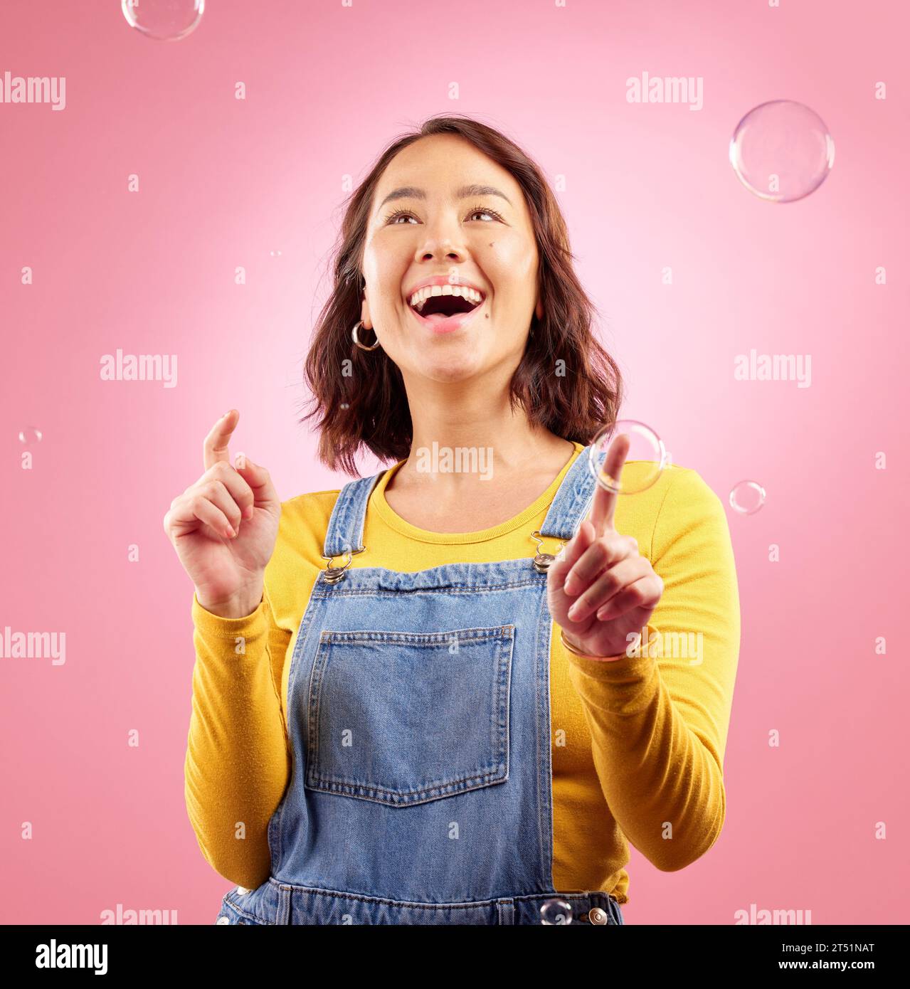 Happy, woman and play with bubbles in studio, pink background and ...