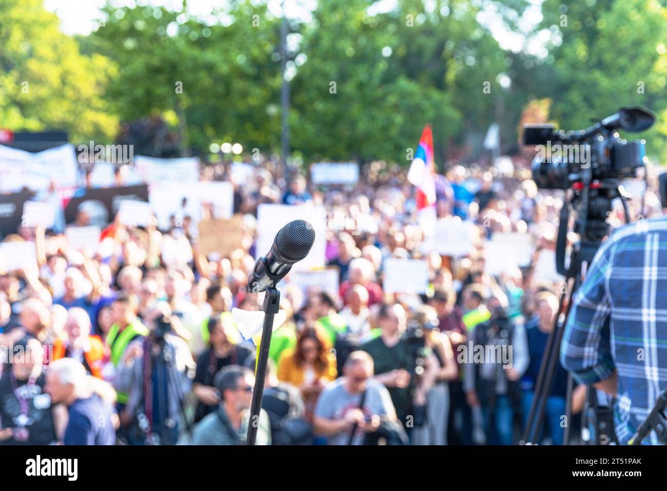 Microphone in focus at mass protest or public demonstration, blurred ...