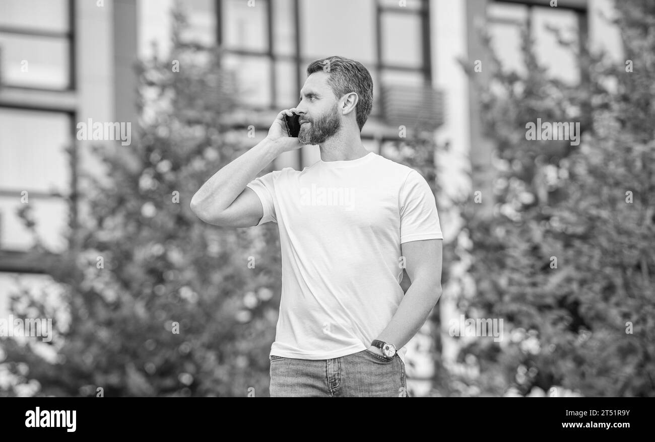adult man has phone call outdoor. man having phone call in the street ...