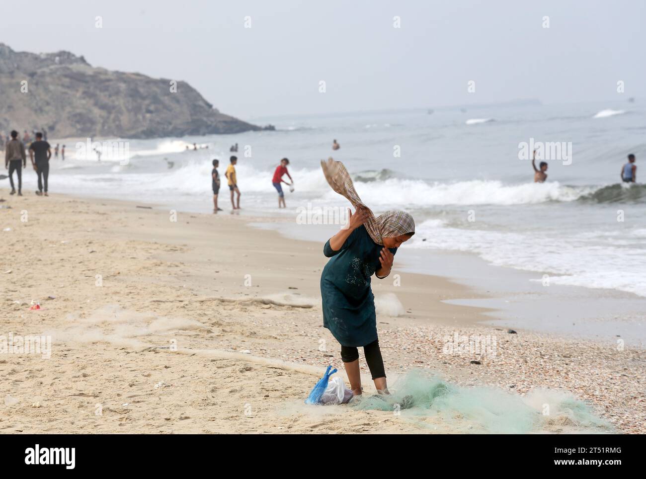 A Palestinian woman washes clothes using sea water due to the lack of ...