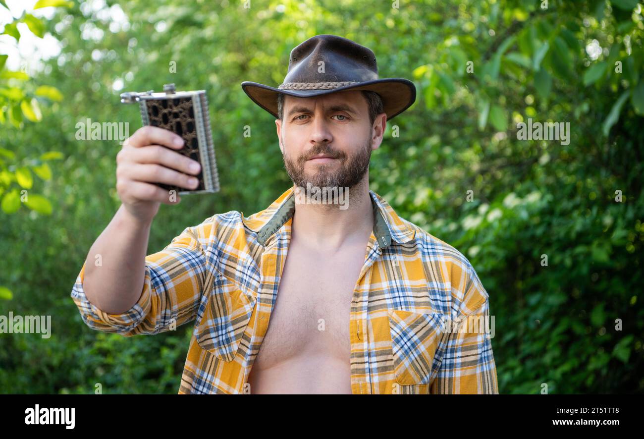 western man cheering with whiskey flask. western man with whiskey flask ...