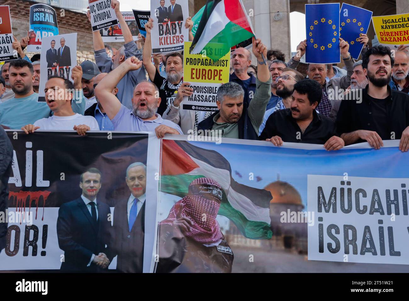 Istanbul, Turkey. 27th Oct, 2023. Protesters hold banners and placards ...