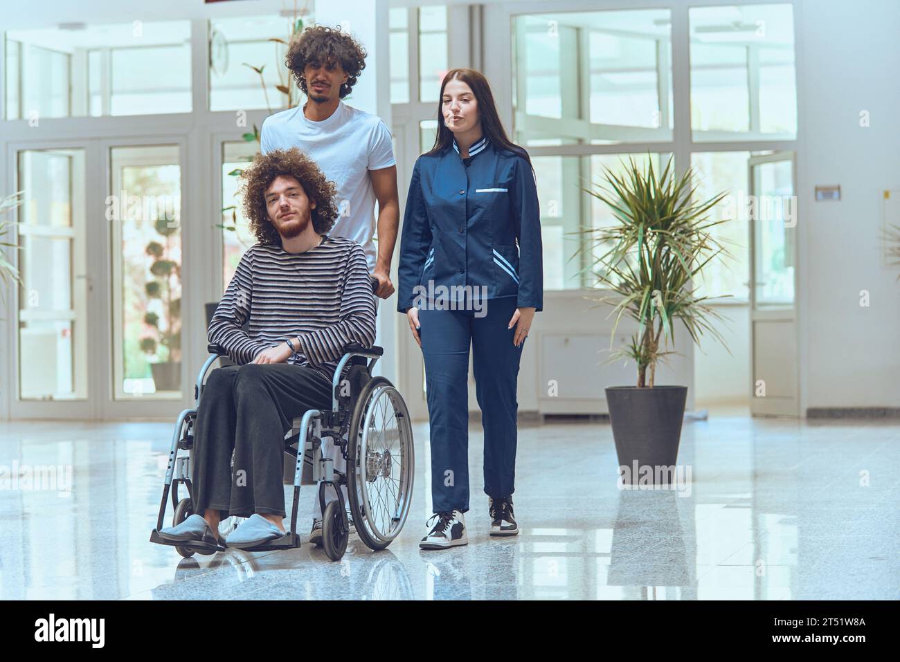 A doctor and a nurse work together to transport a patient in a ...