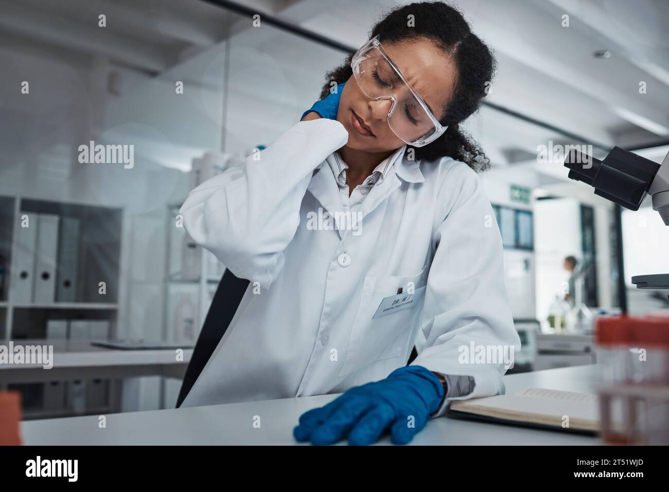 Stress, woman or scientist with neck pain in a laboratory suffering ...