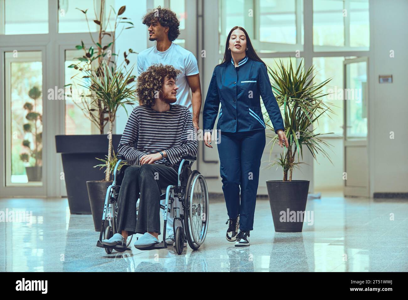 A doctor and a nurse work together to transport a patient in a ...