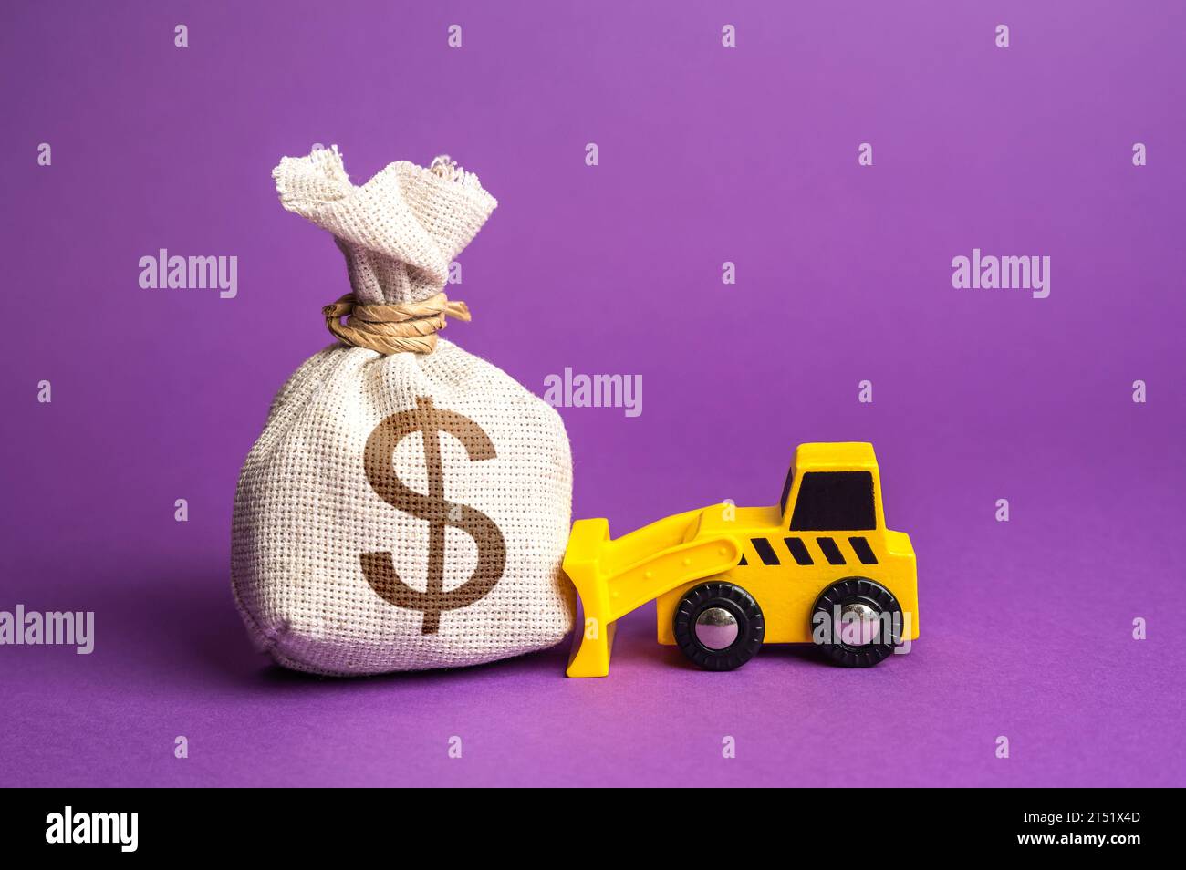 A bulldozer pushes a dollar money bag. Ineffective use of funds ...
