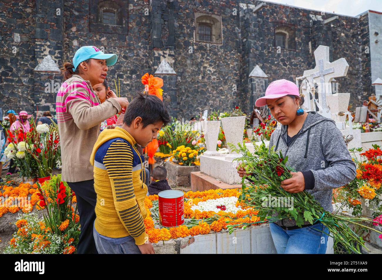 MEXICO CITY, MEXICO - NOVEMBER 2: A family decorates the grave of their ...