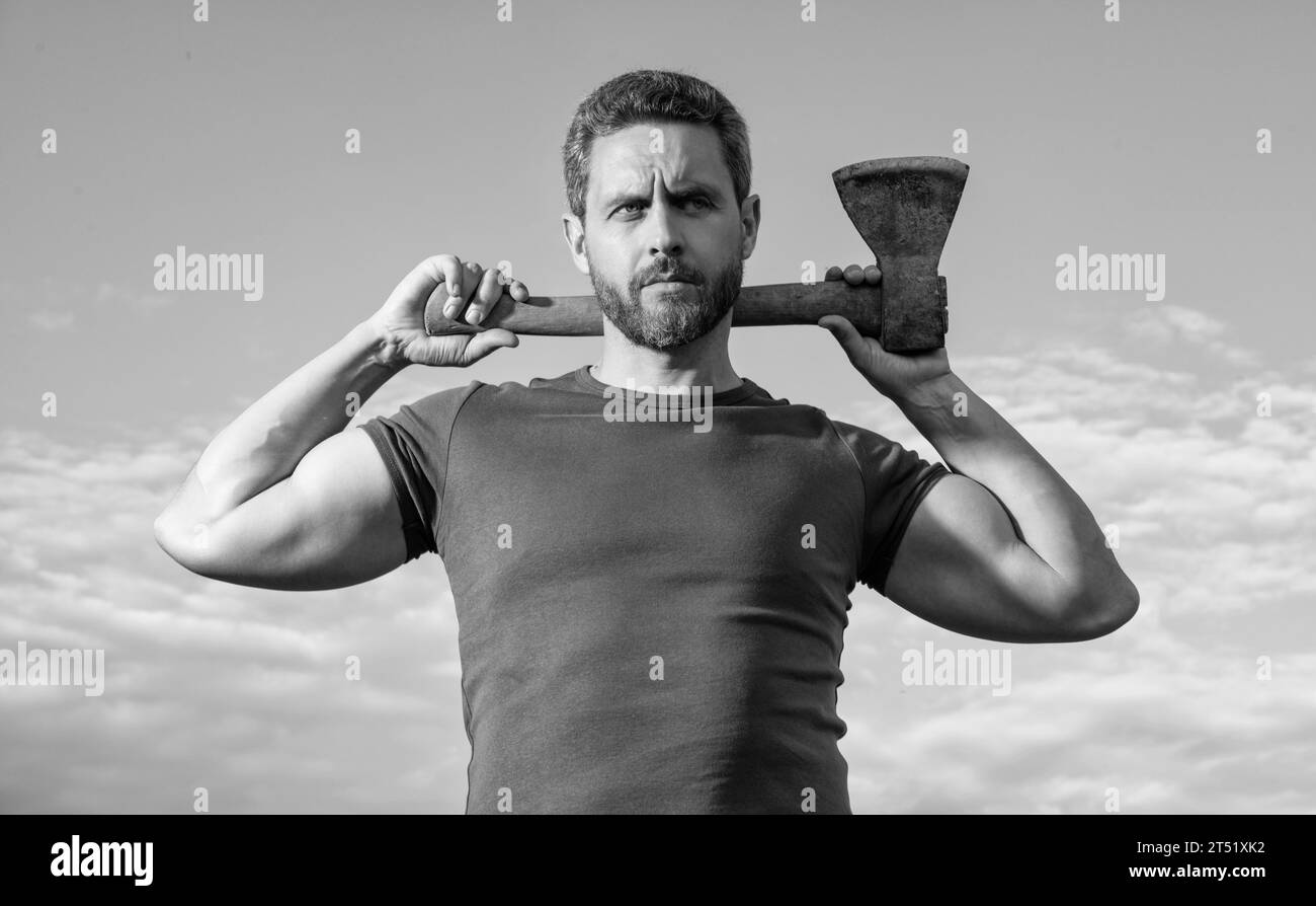 confident man with axe. logger man hold ax. brutal man on sky ...