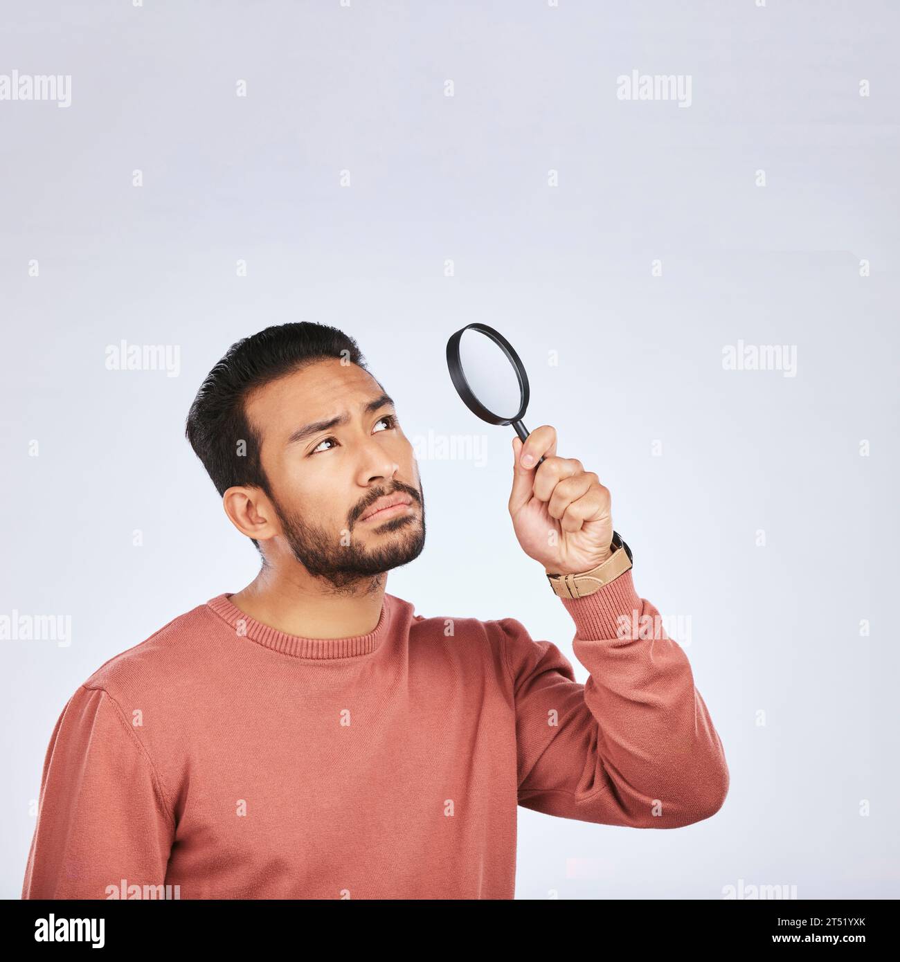 Magnifying glass, man and serious in a studio with investigation for ...