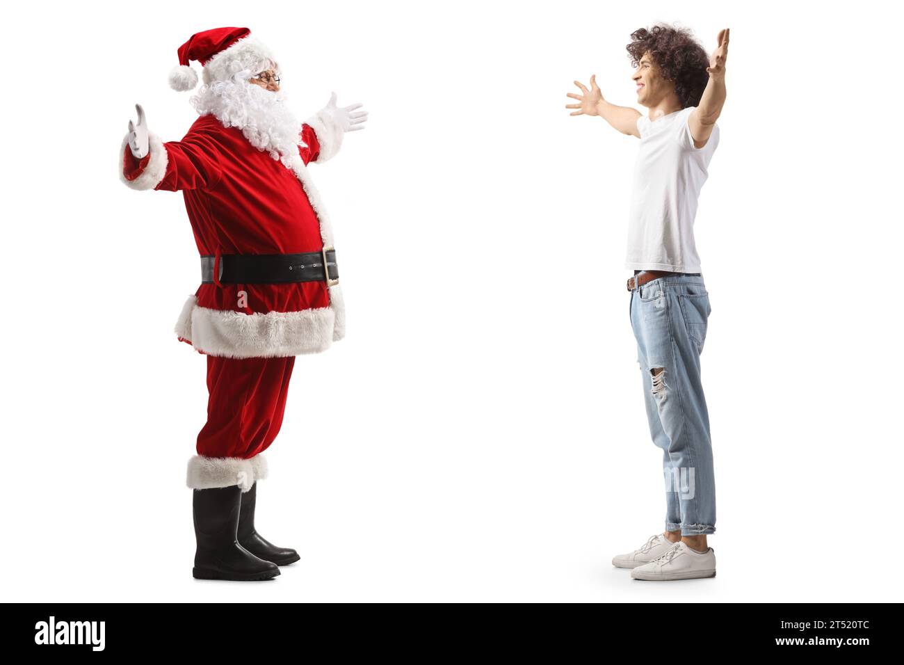 Full length profile shot of santa claus meeting a young man with arms ...