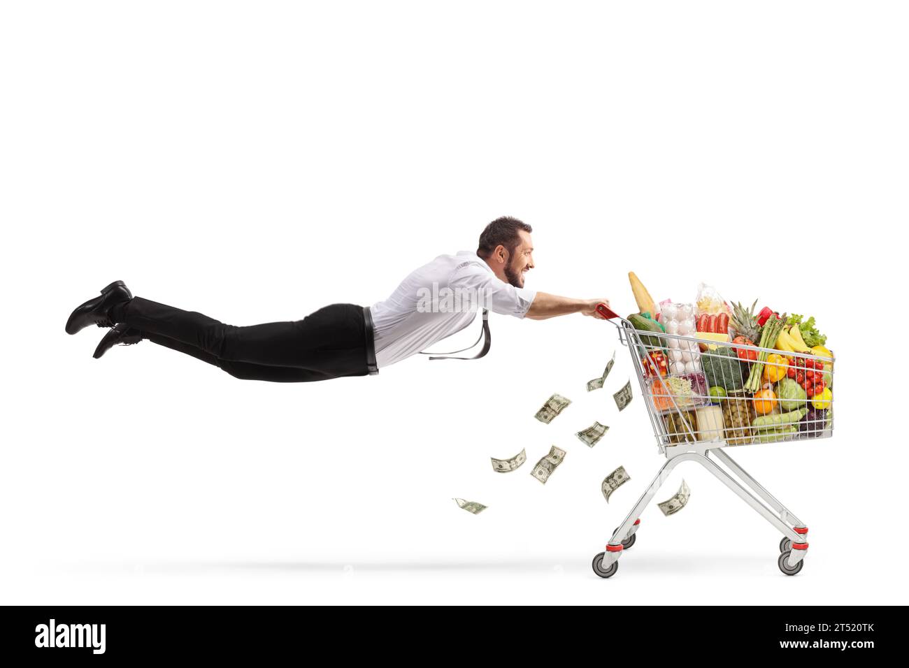 Man flying and holding a shopping cart with food and money isolated on ...