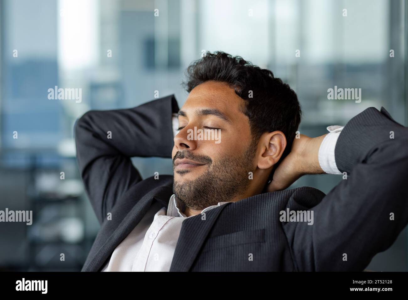 Young male businessman close-up resting in office, boss in business ...