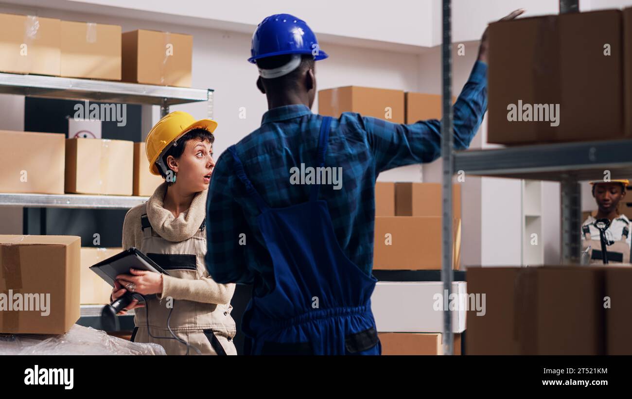 Man and woman scanning goods in warehouse depot, using digital tablet ...
