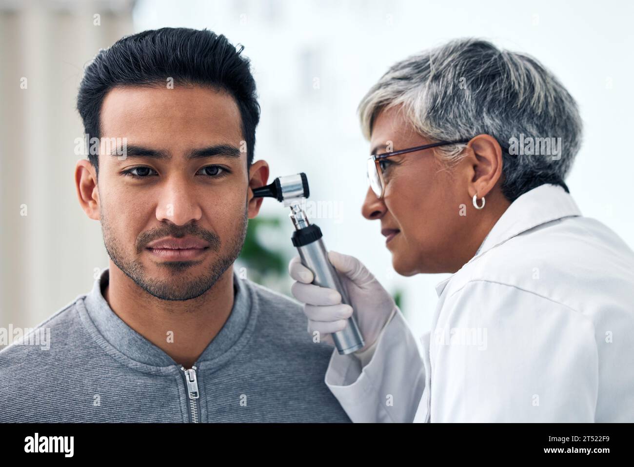 Ear check, woman and ENT doctor with patient consultation for hearing ...