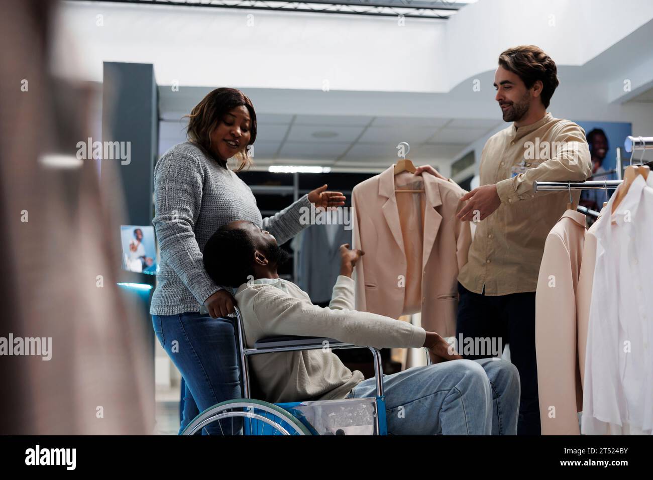 Man with physcial disability choosing jacket with girlfriend while ...