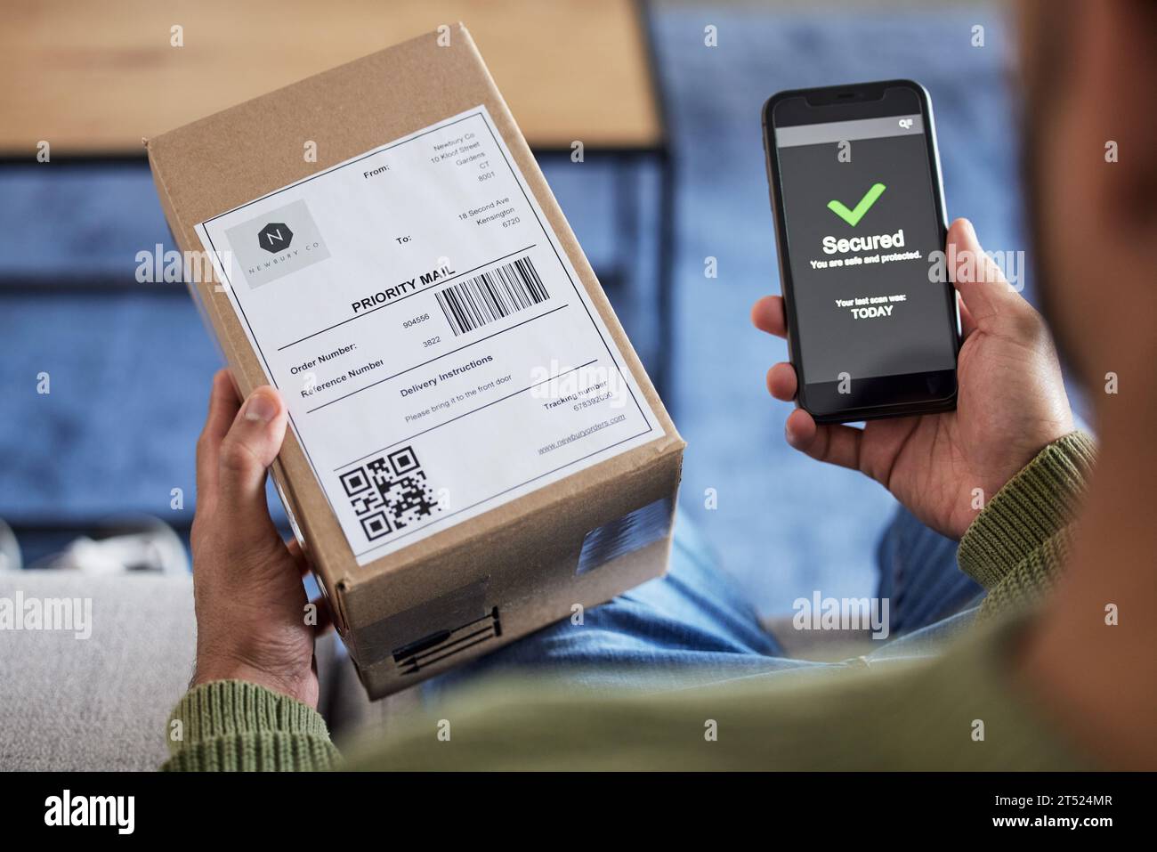 Box label, phone screen and person hands reading security verification ...