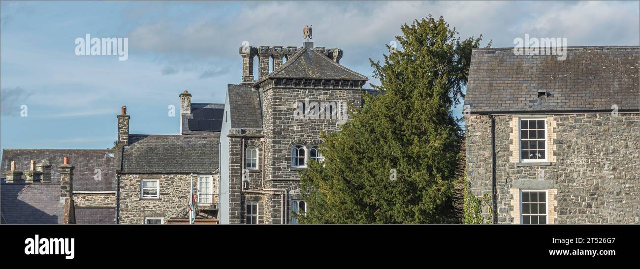 Old grey slate typical Welsh buildings with multiple chimneys against a ...
