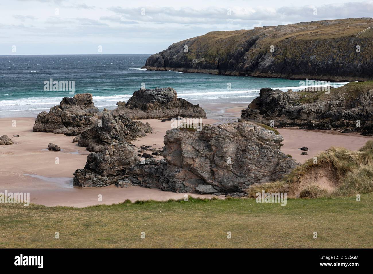 Remote Scottish rocky beach looking out across a turquoise sea Stock ...