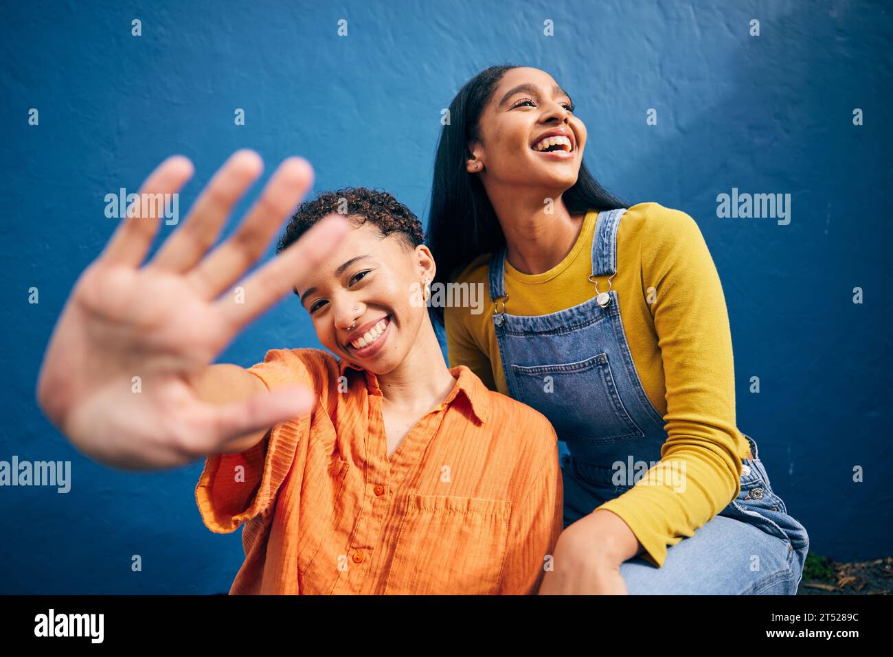 Selfie, portrait and women in city on blue background for social media ...