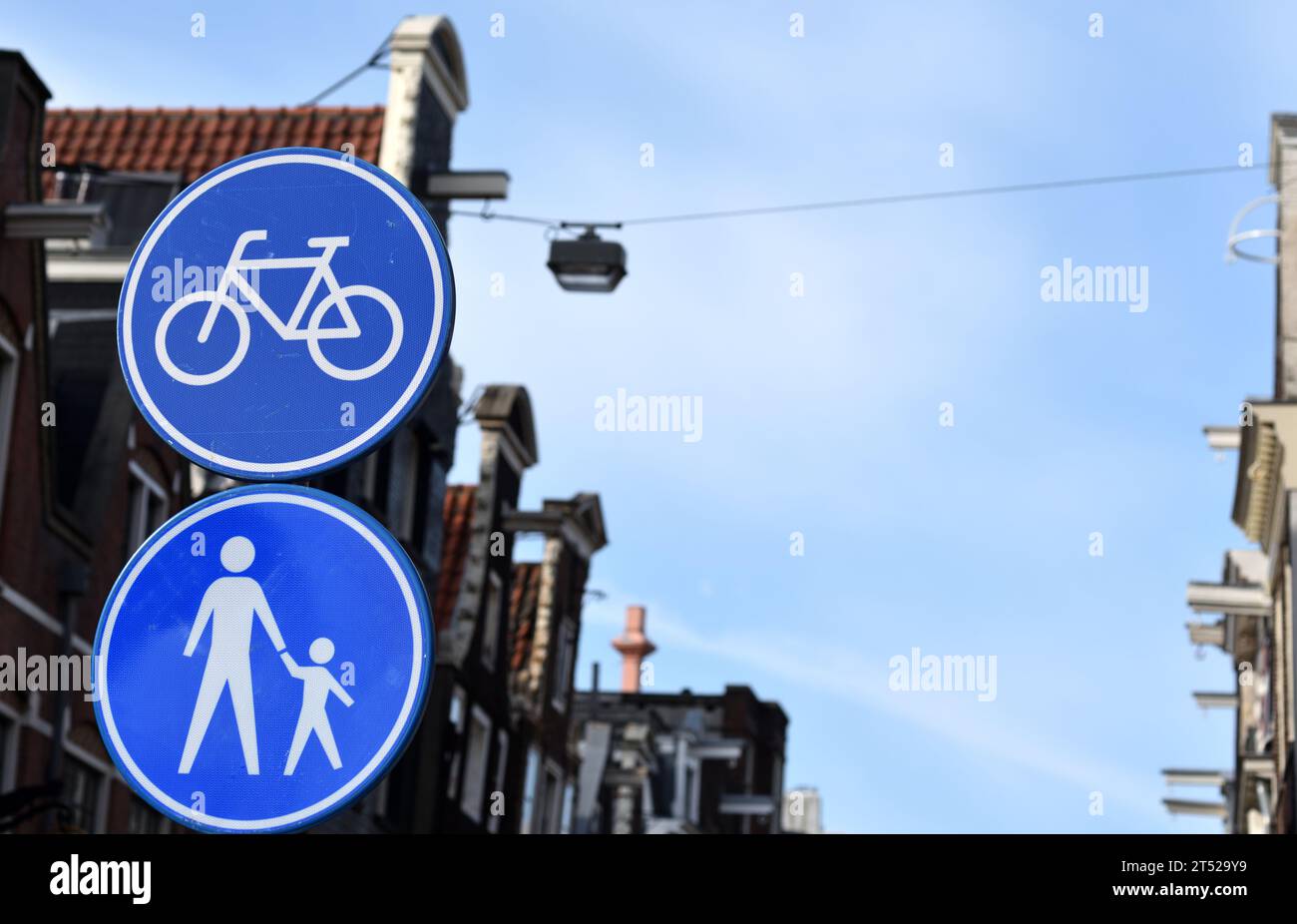 A busy street corner in an urban cityscape, with a variety of traffic ...