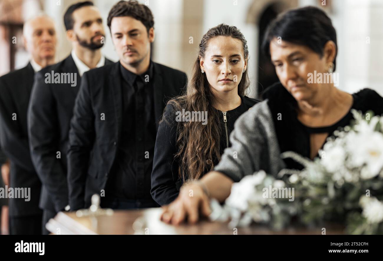 Funeral, goodbye and family with a coffin in a church during a service ...