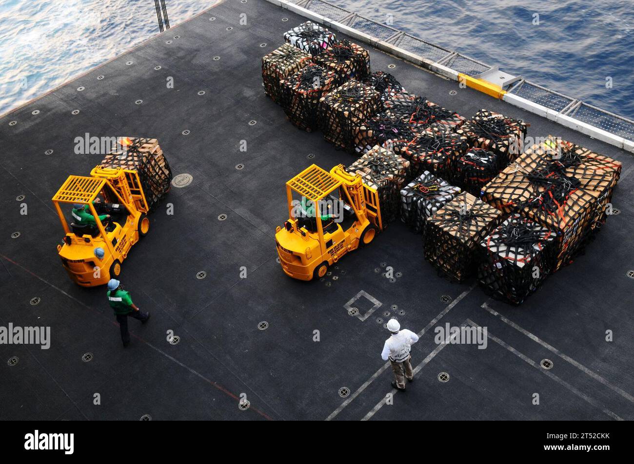 110707IC111-048 ARABIAN SEA (July 7, 2011) Sailors move cargo pallets ...