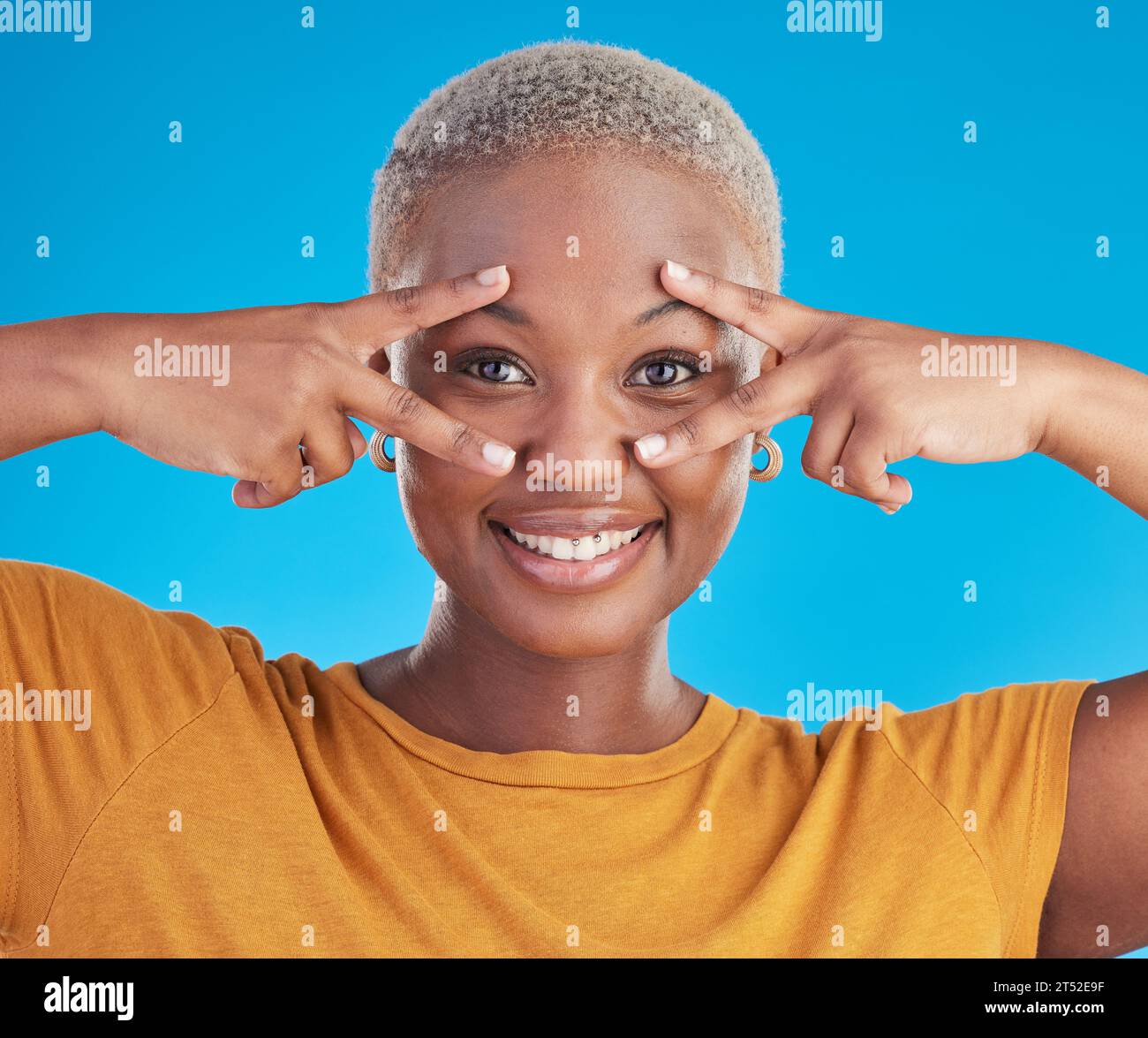 Face, peace sign or happy black woman in studio isolated on blue ...