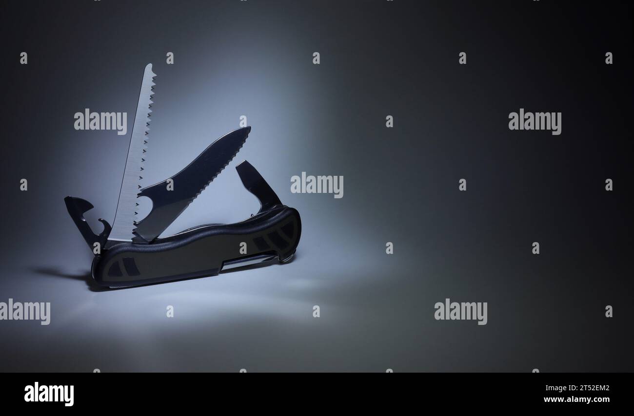 Multifunctional, outdoor folding pocket knife Multi-Tool on a black ...