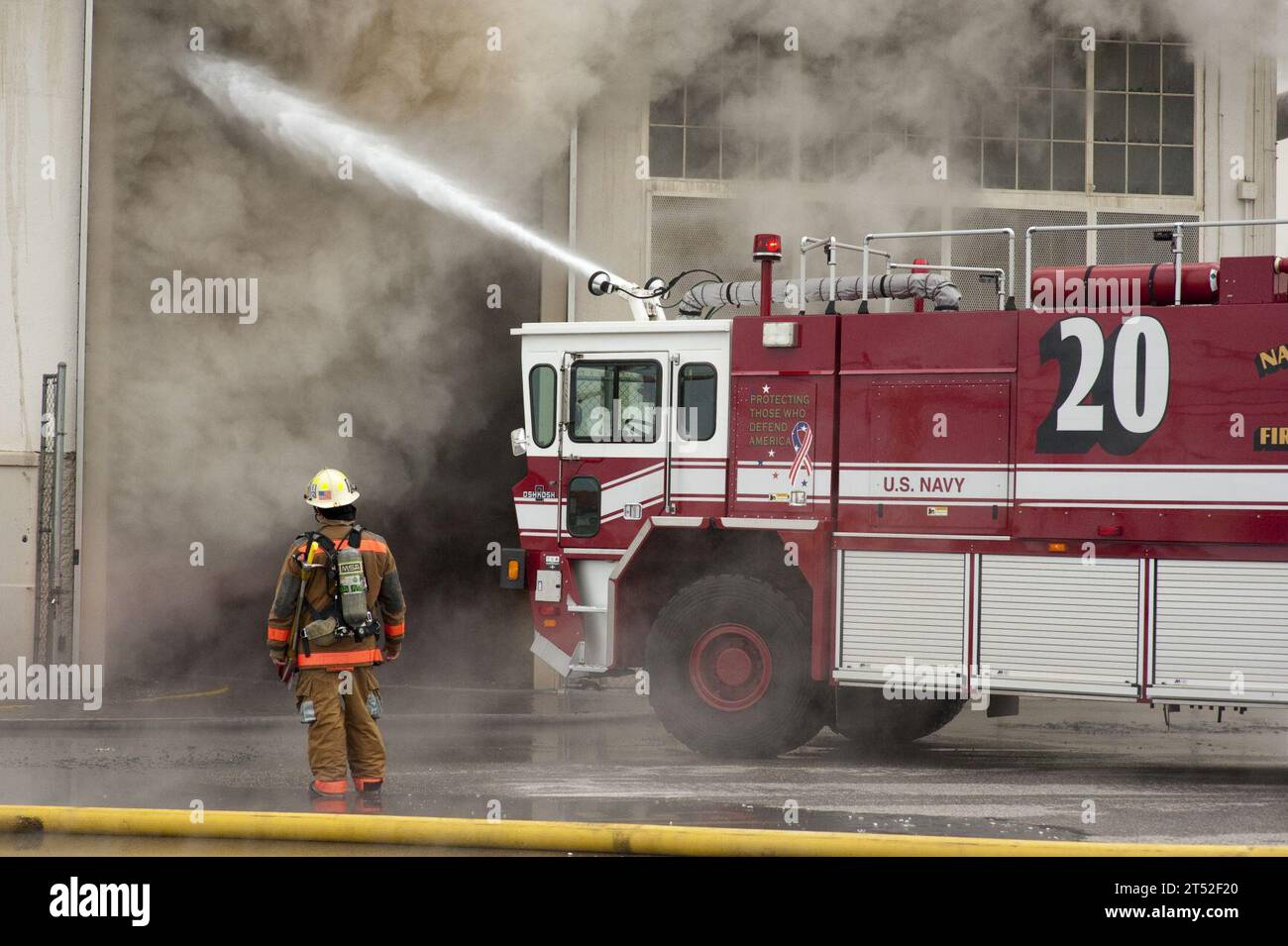 1101275319A-012 NORFOLK (Jan. 27, 2011) Firefighters work to put out a ...