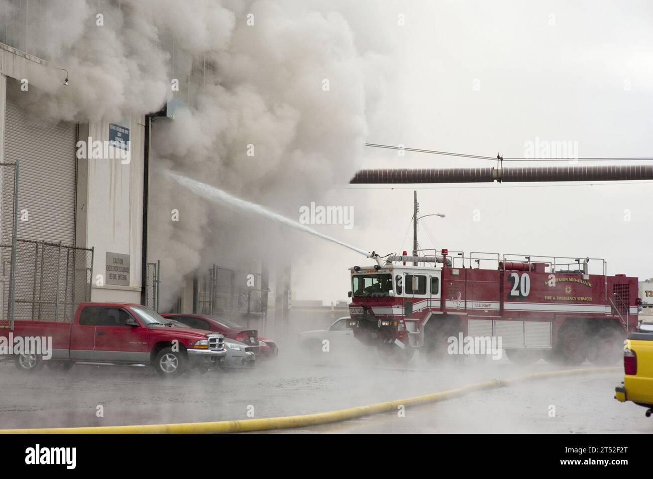1101275319A-013 NORFOLK (Jan. 27, 2011) Firefighters work to put out a ...