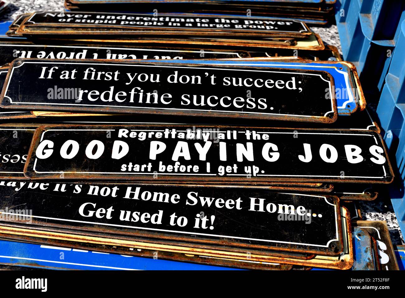 A collection of black street signs with white text displayed in a ...