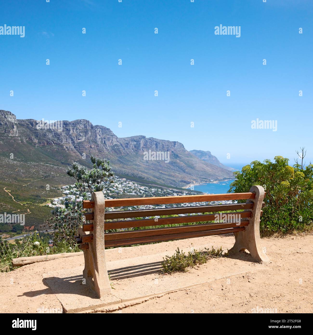 Bench with a beautiful view of the mountain and sea against a clear ...