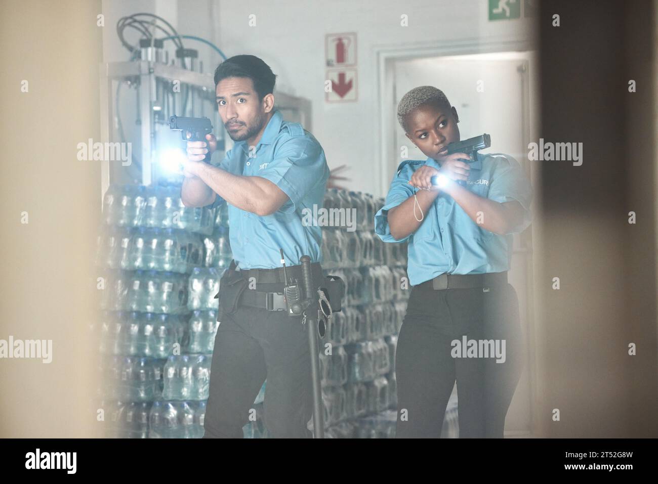 Police, man and woman with gun, investigation and inspection with torch ...