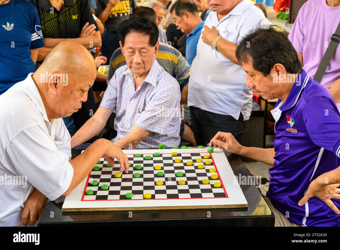 Ethnic Chinese Men Playing Board Games on the street with an audience ...