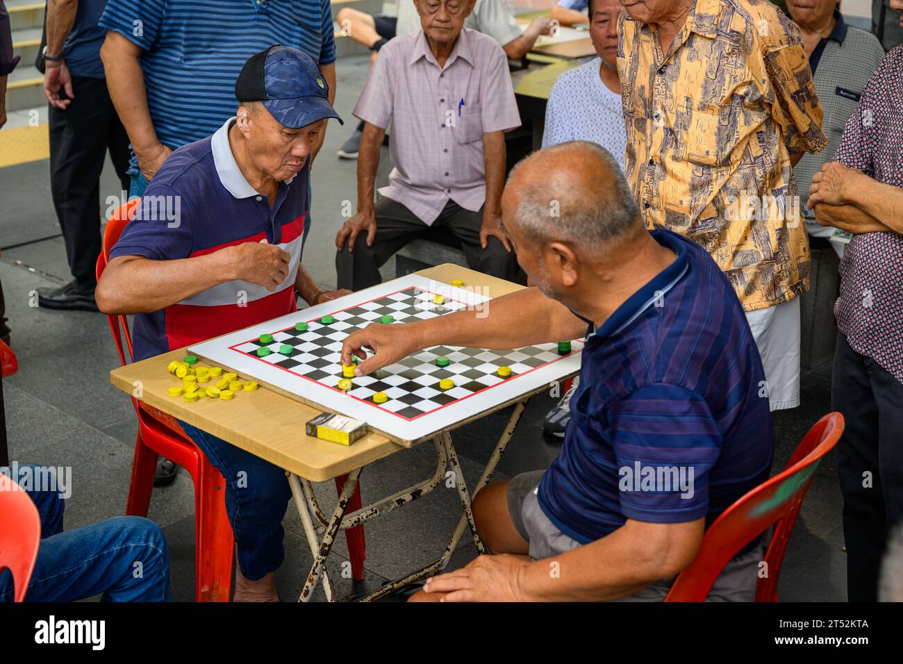 Ethnic Chinese Men Playing Board Games on the street with an audience ...