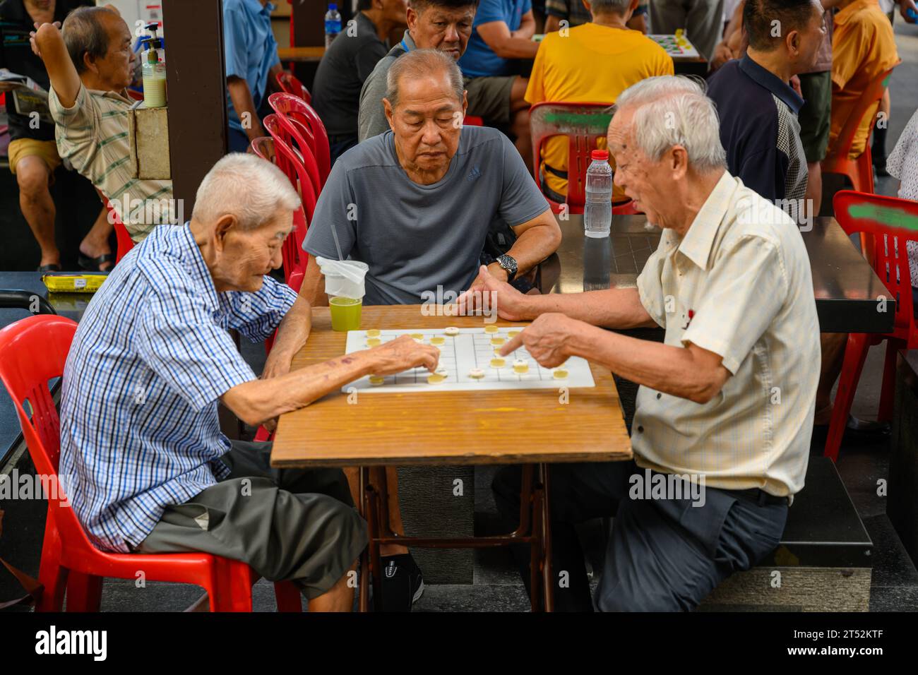 Ethnic Chinese Men Playing Board Games on the street with an audience ...