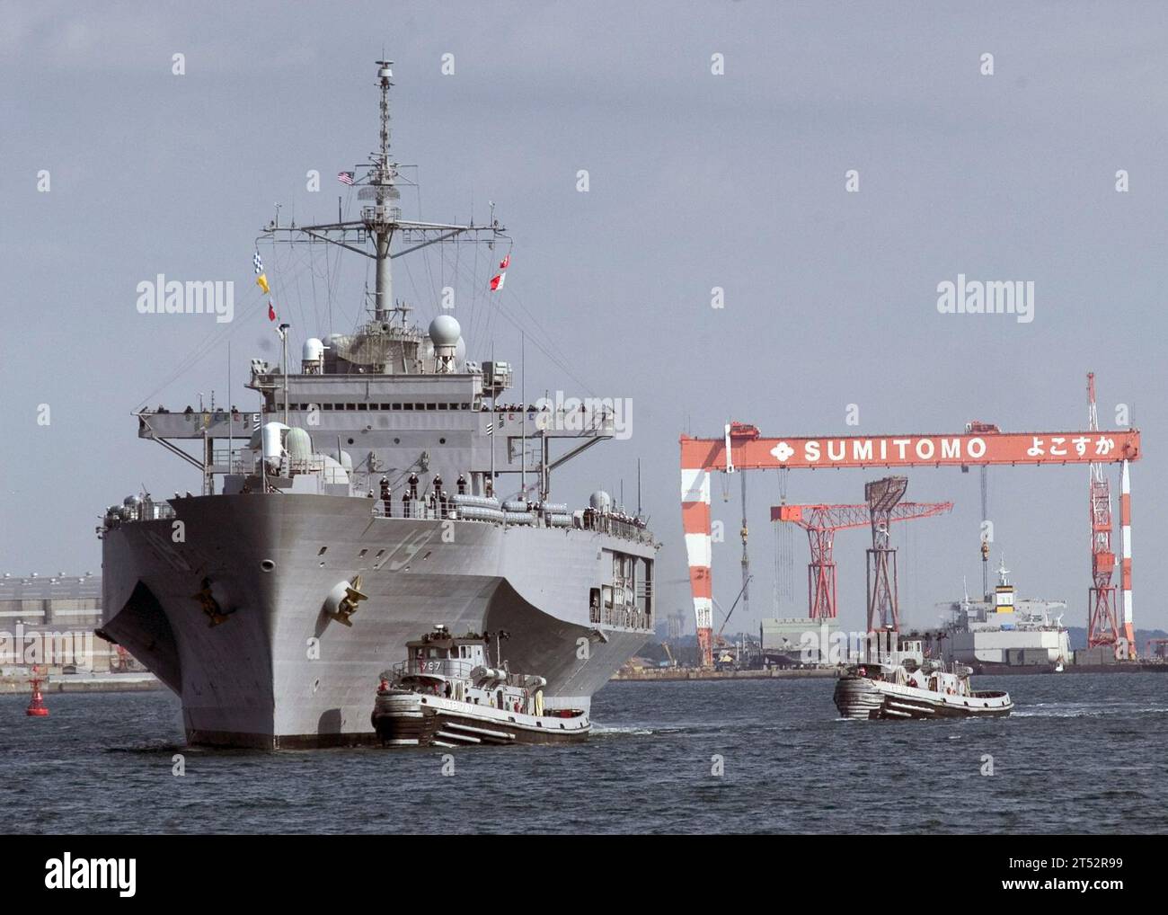 0703215253W-001 YOKOSUKA, Japan (March 21, 2007) - Tugs come alongside ...