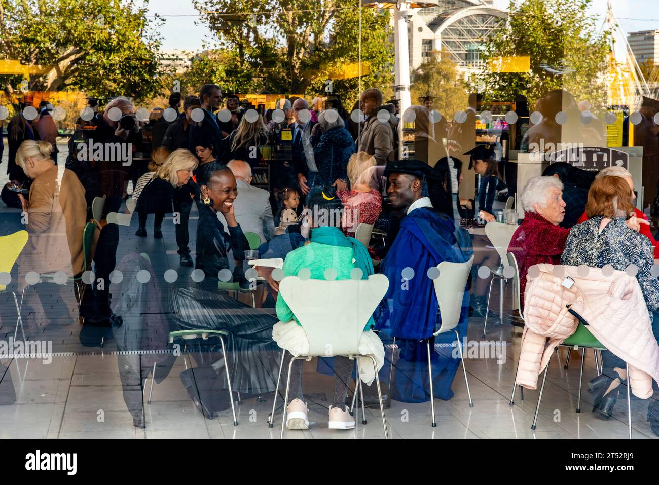 A Student In Traditional Costume Sitting In A Cafe At His Graduation ...