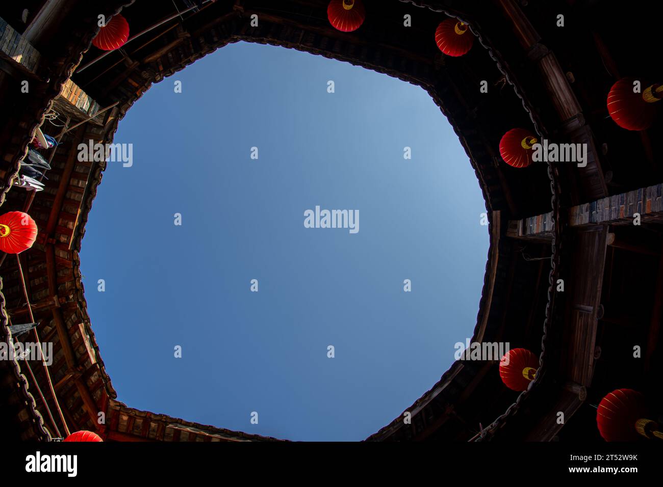 The sky above the round buildings of Hekeng Tulou Cluster in the early ...