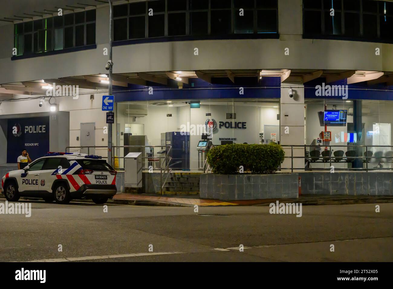 A Singapore Police Station with a parked Police Car at night Stock ...
