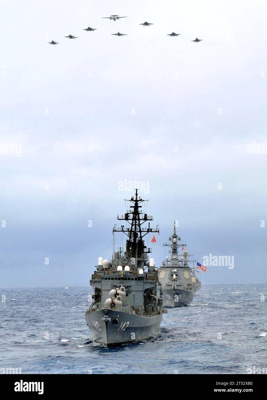 Aircraft fly overhead as the Japanese Maritime Self-Defense Force ...