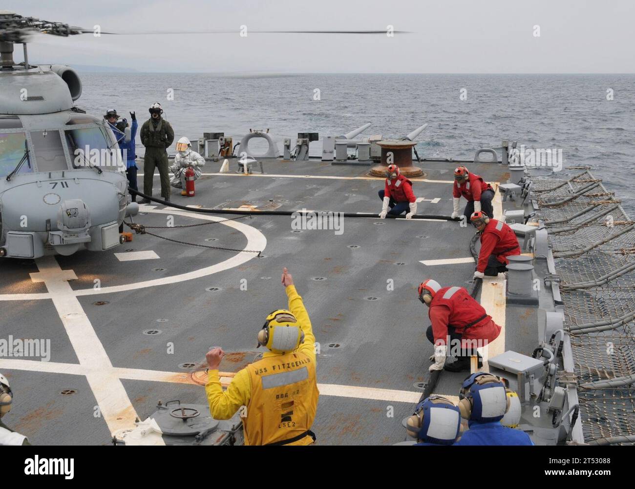 1103218288P-108 PACIFIC OCEAN (March 21, 2011) Sailors signal to each ...