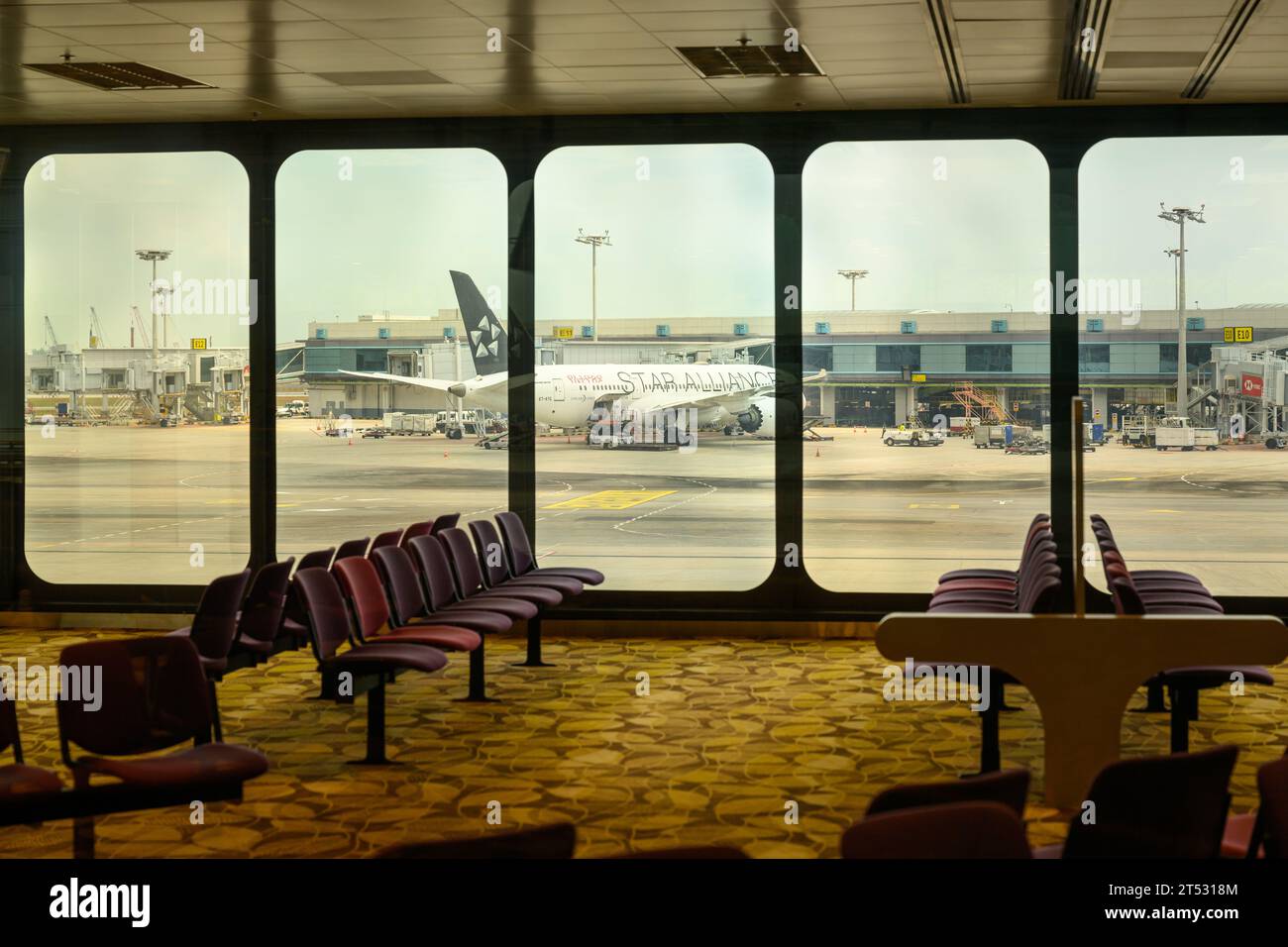 View of the apron through a departure gate window at Singapore Changi ...