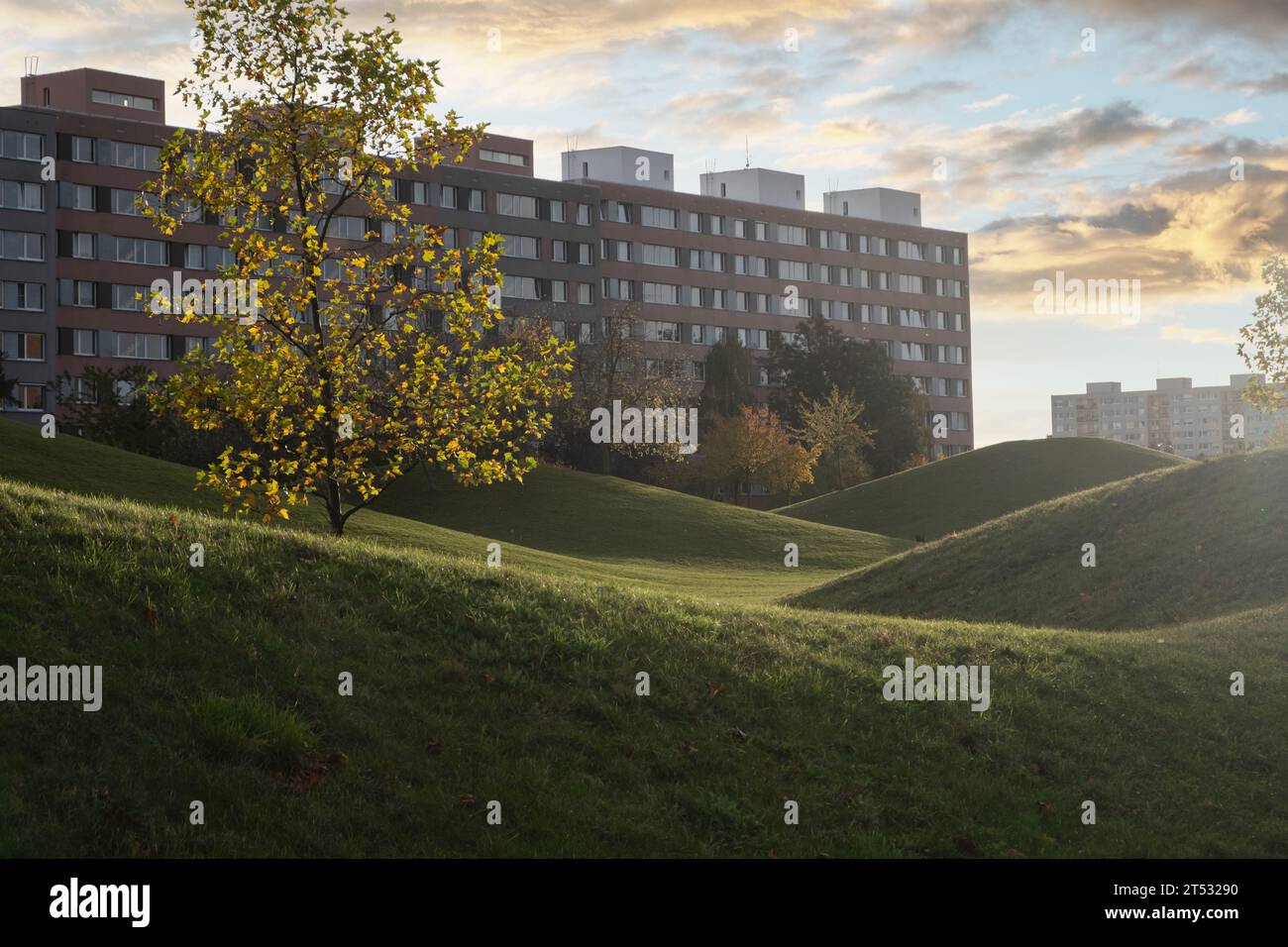 city park in Prague, featuring lush green grassy hills, is illuminated ...