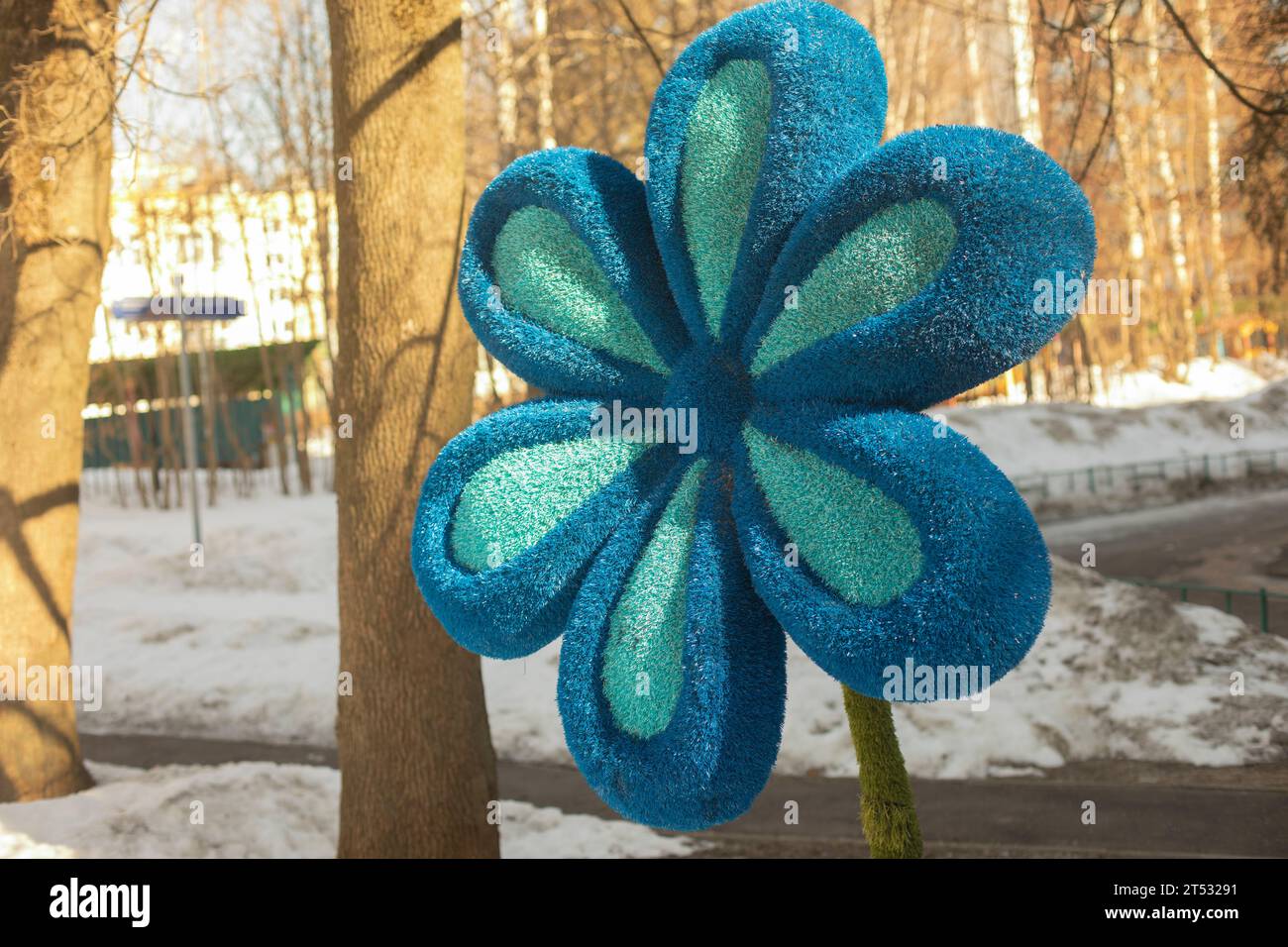 Big blue flower in park. Decoration in city. Children's area in detail ...