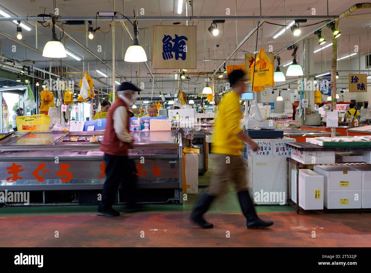 Marufuto fish store staff member Kazuto Harada, right, attends a ...