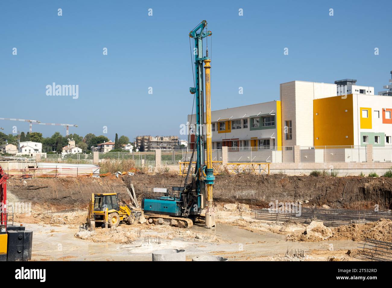 machine mechanism diligently excavates the ground at a construction ...